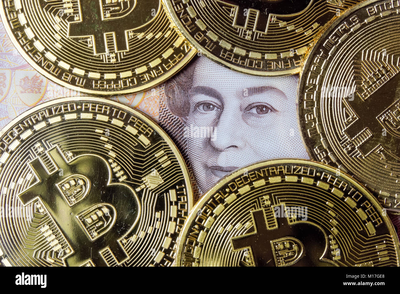 Bitcoin cryptocurrency coins on the ten pound note Stock Photo - Alamy