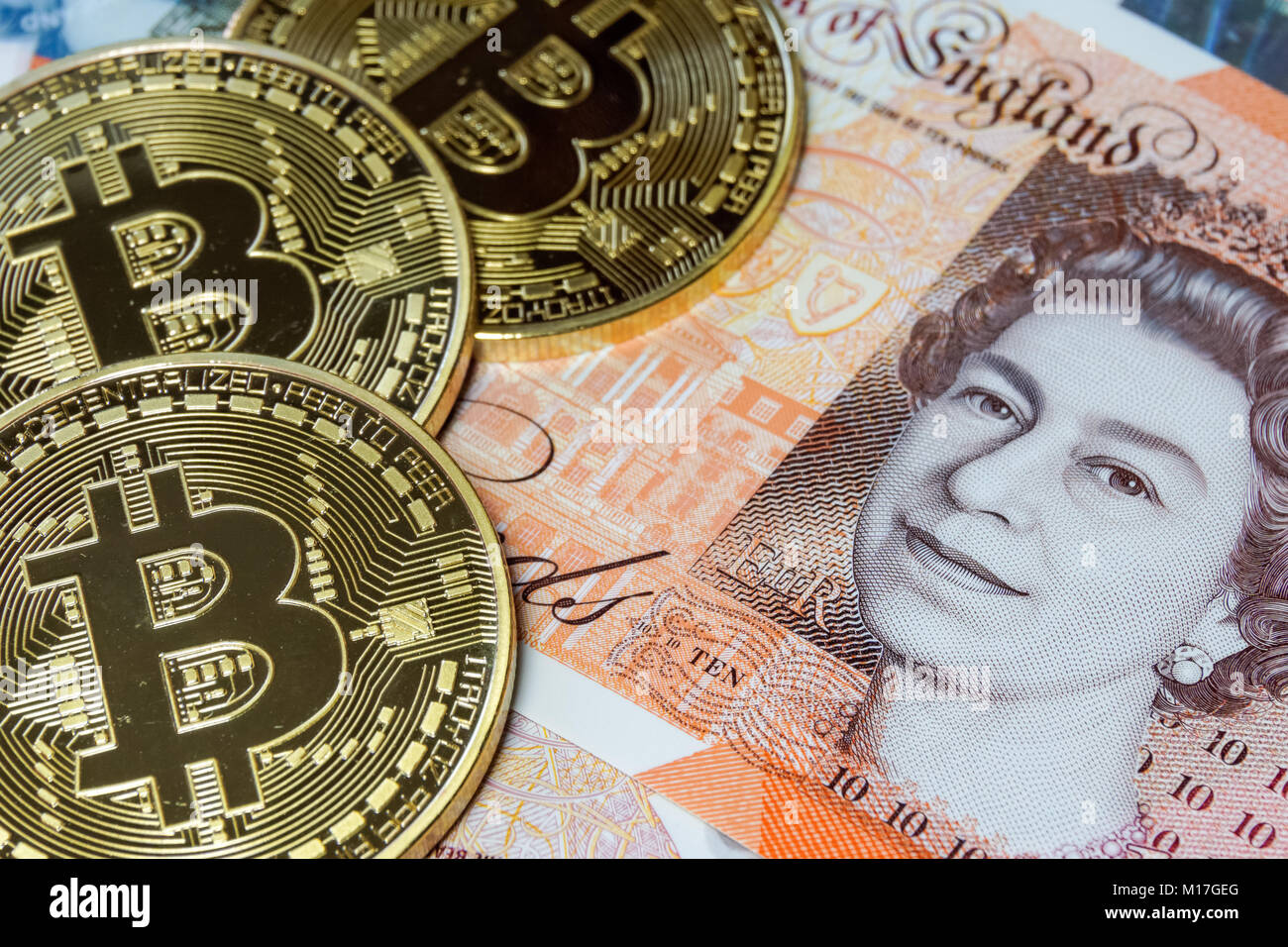Bitcoin cryptocurrency coins on the ten pound note Stock Photo - Alamy