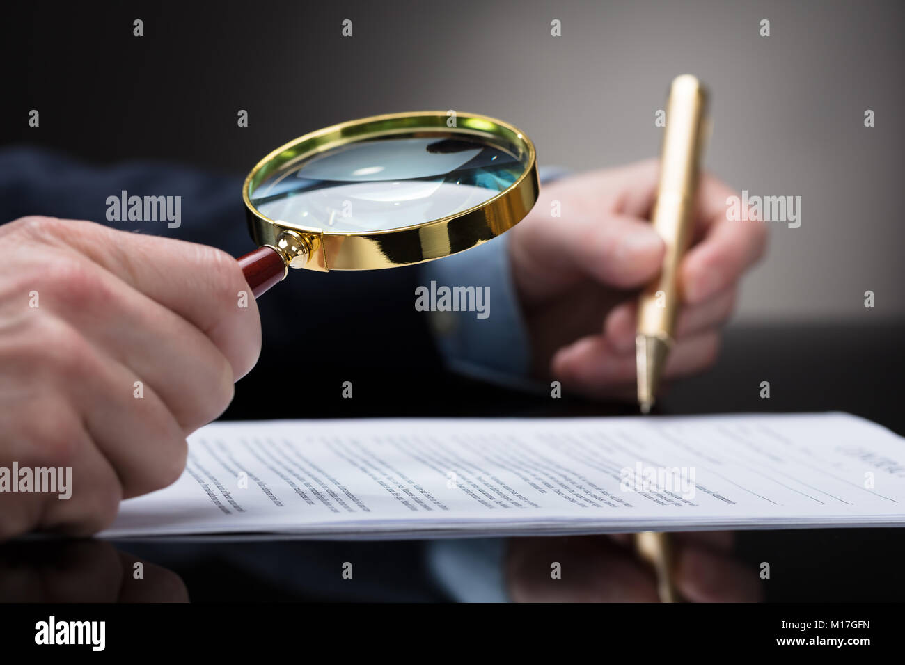 Signing a contract magnifying glass hi-res stock photography and images ...