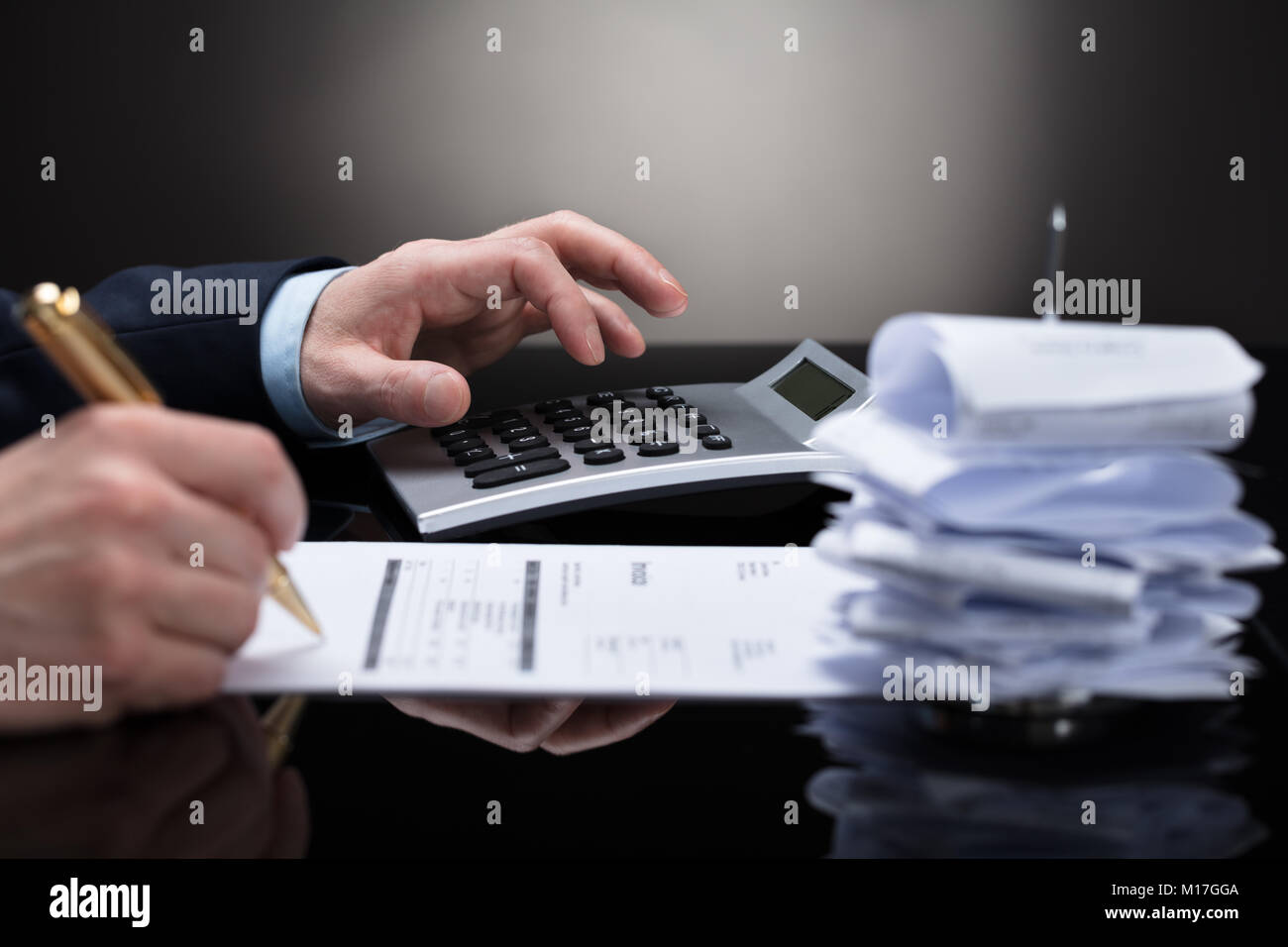 Businessperson Checking Invoice With Receipts On Desk Stock Photo - Alamy