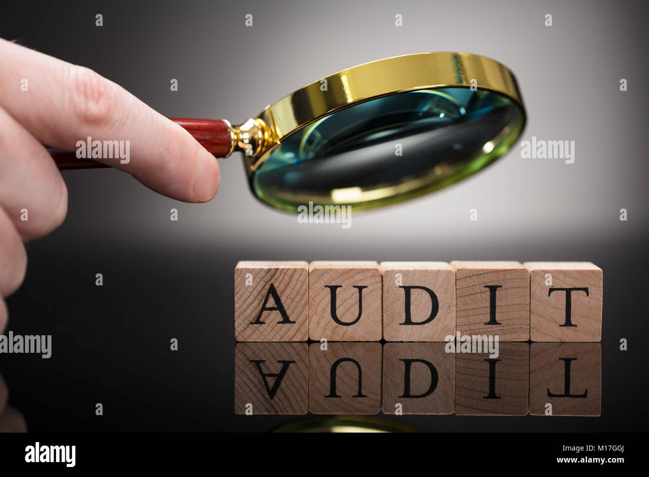 Close-up Of A Person Examining Audit Blocks Through Magnifying Glass ...