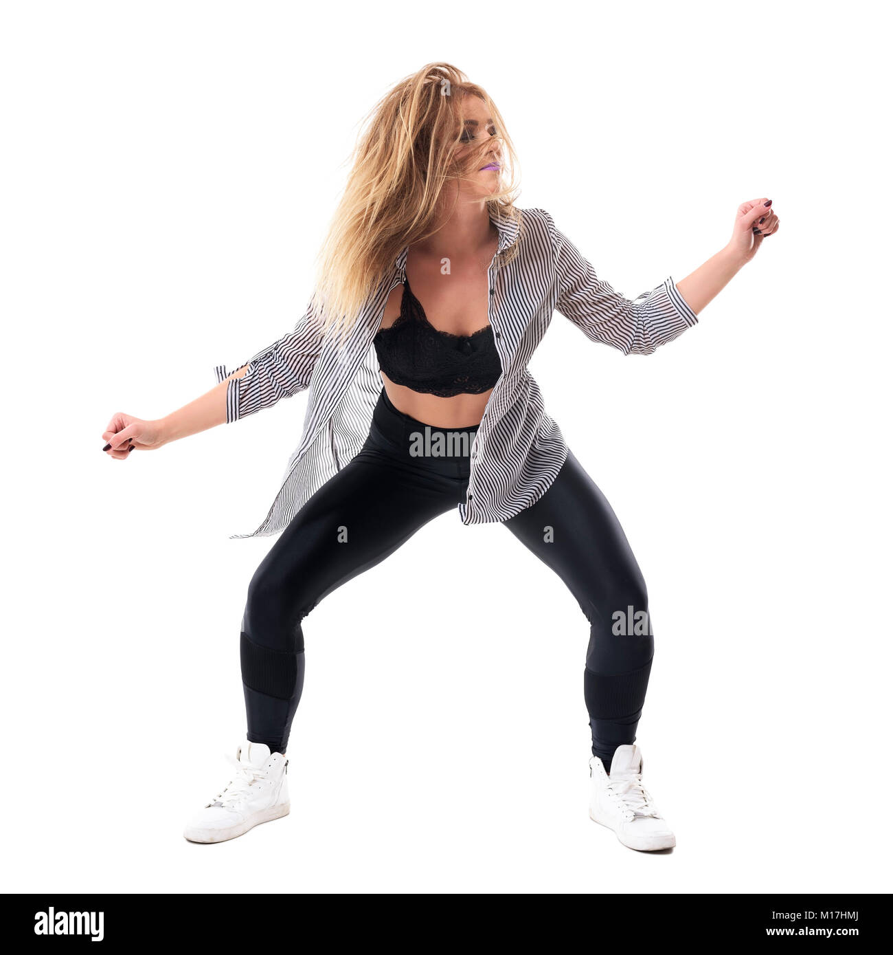 Front view of crouching aerobics jazz dance instructor with tousled ...