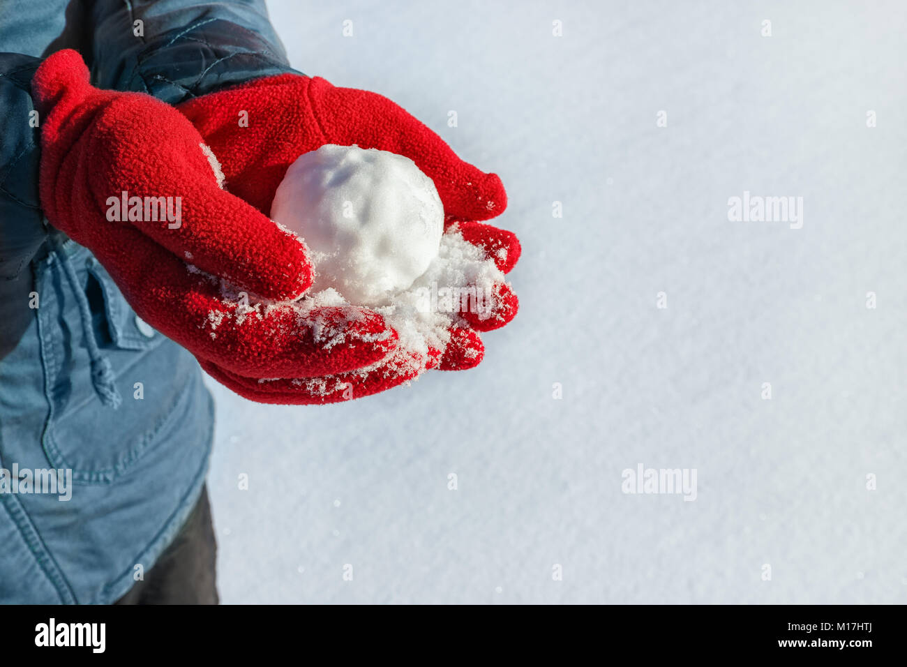 hands in red gloves holding snowball Stock Photo - Alamy