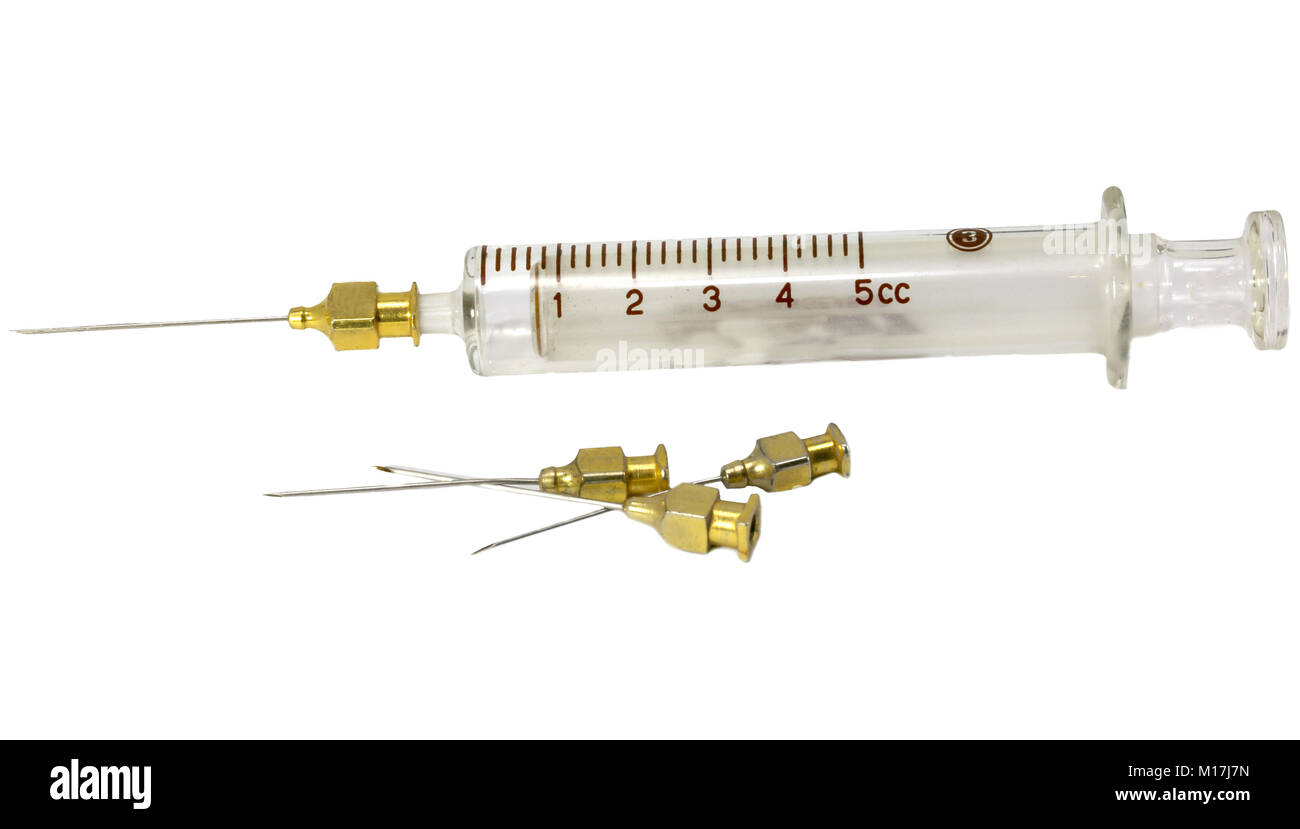 ancient medical syringe in glass with many stainless steel needles ...