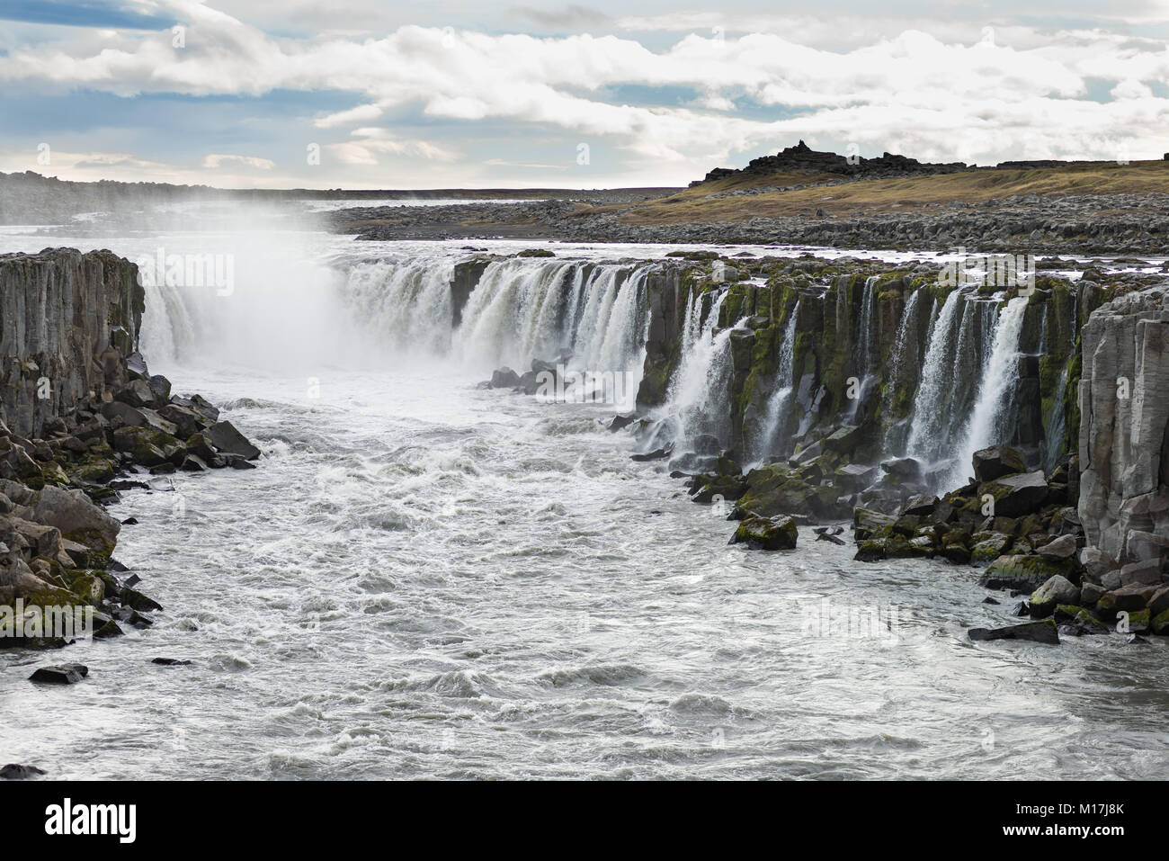 Selfoss waterfalls in Northern Iceland with storm clouds in background ...