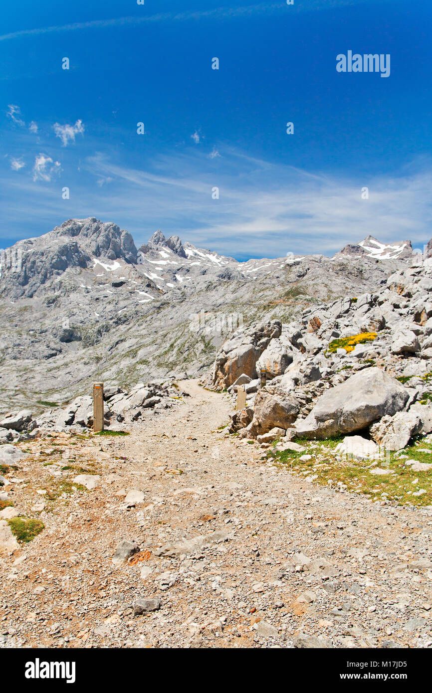 Stony track in mountains of Picos de Europa and tourists, the vicinity of Fuente De. Sunny day ...