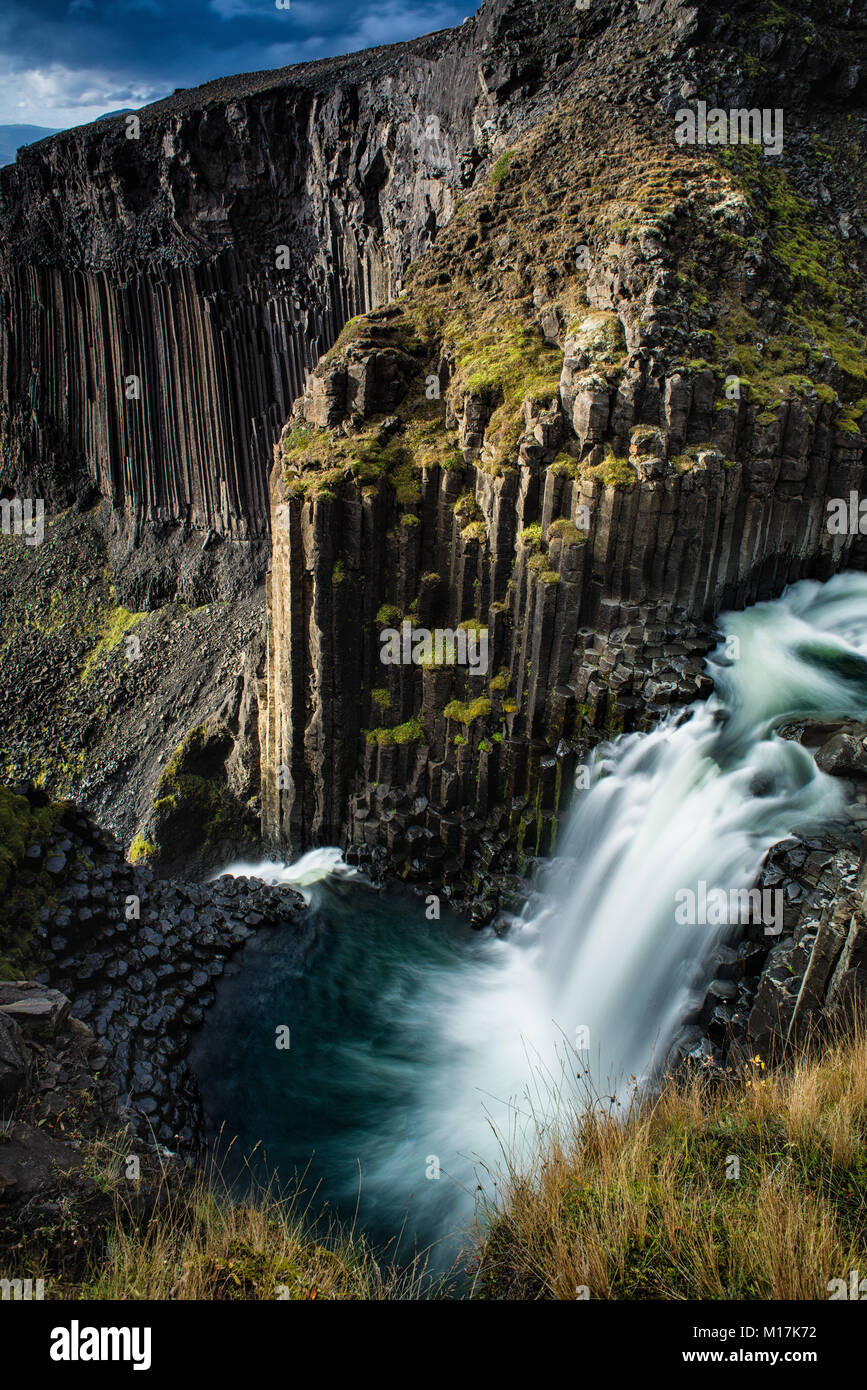 Litlanesfoss waterfall and river flowing between basalt columns on a ...