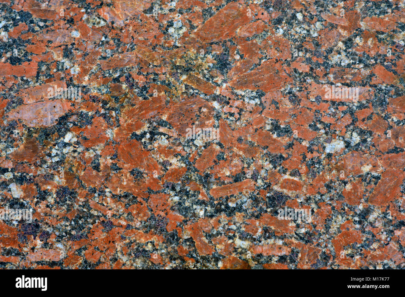 Red grey granite background and wallpaper. Blotches of red granite in a ...