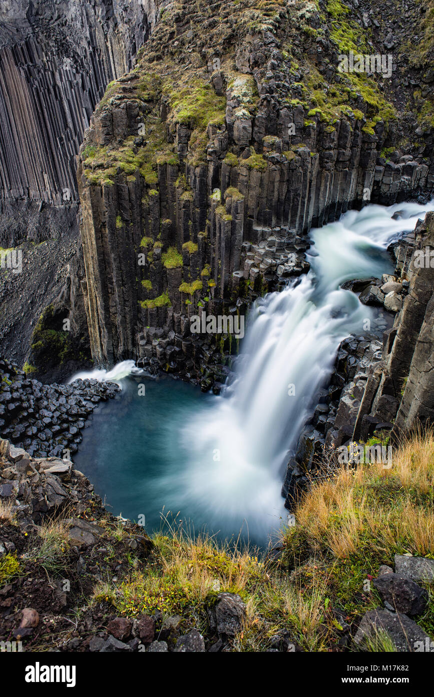 Litlanesfoss waterfall and river flowing between basalt columns on an ...
