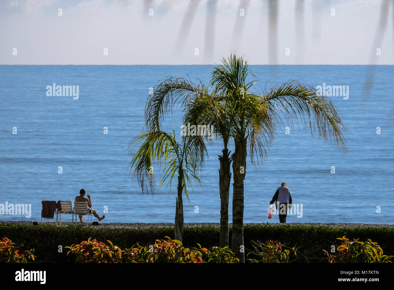 People enjoying the sun on the beach in January in Larnaca, Cyprus ...