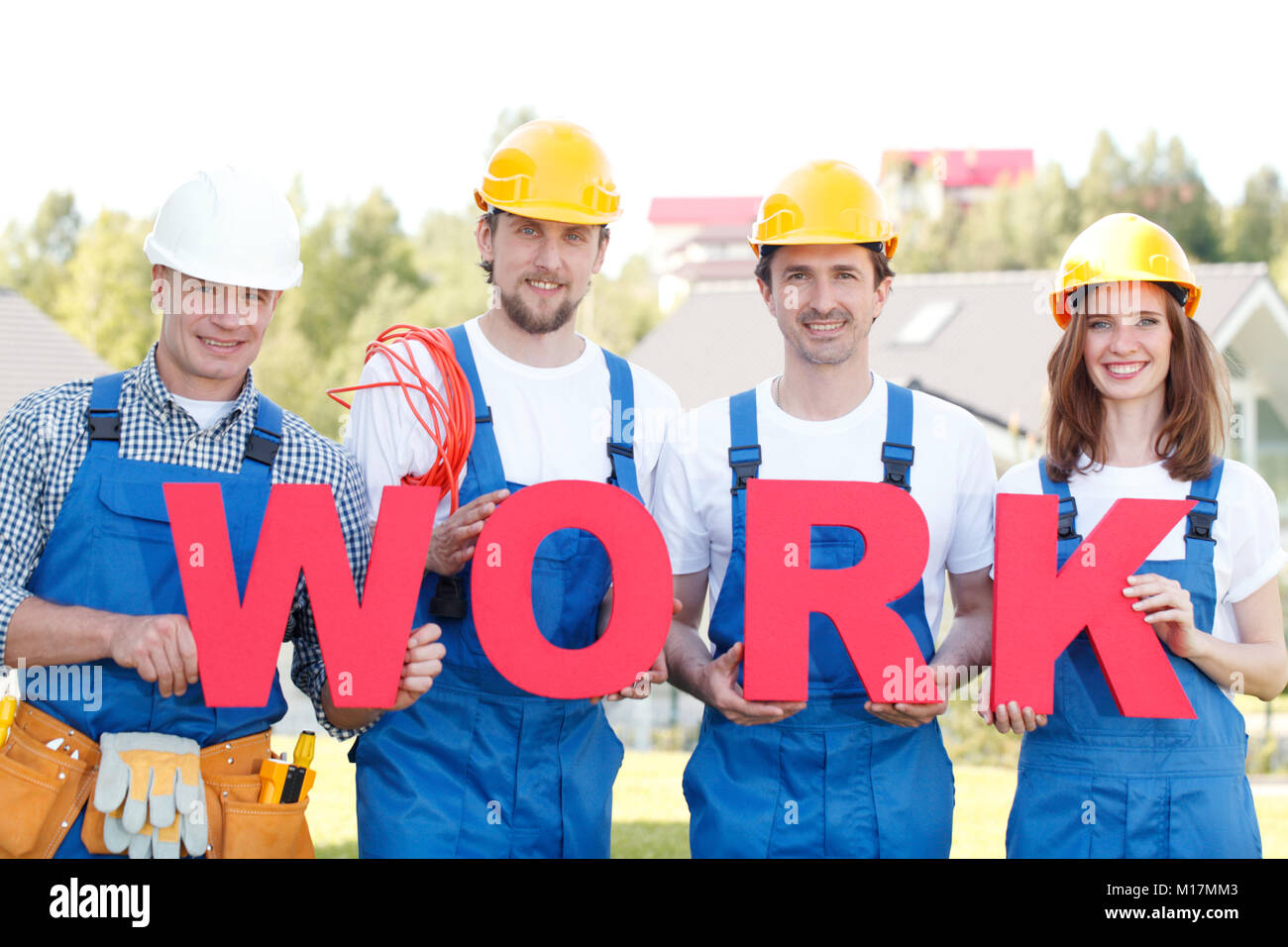 Group of workmen with word work outdoors Stock Photo - Alamy