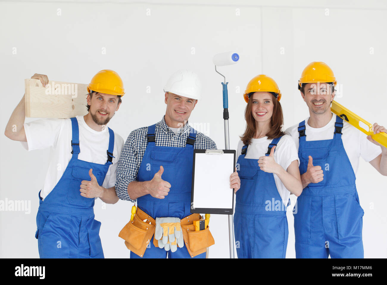 Team of happy smiling workers with tools and contract Stock Photo - Alamy