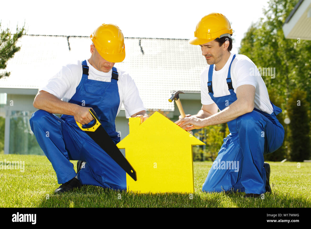 Workers with tools and house symbol. Construction concept Stock Photo ...