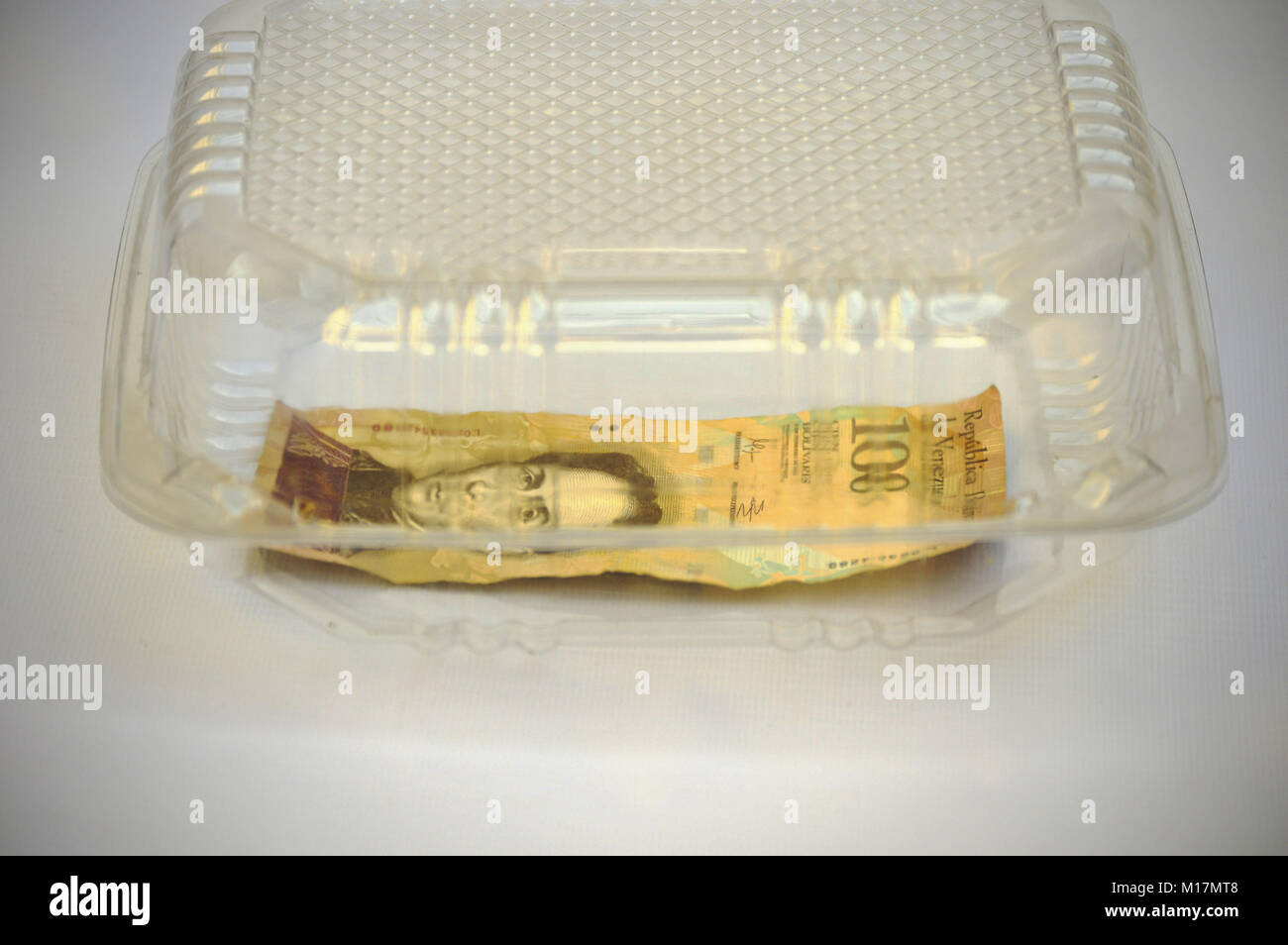 Bank notes inside plastic container. Cash crisis concept Stock Photo ...