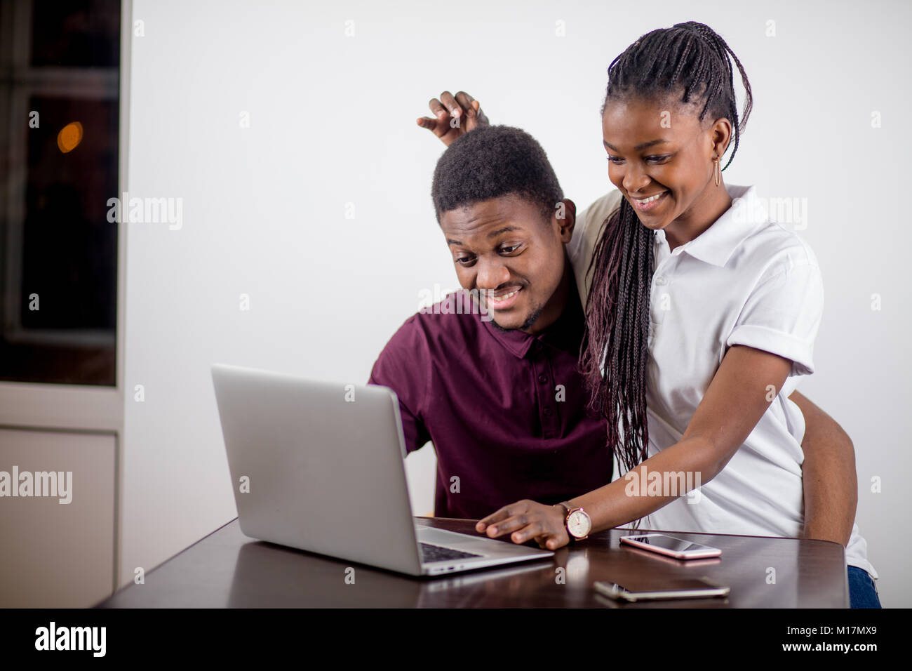 black girl sitting in front of laptop s looking on screen Stock Photo ...