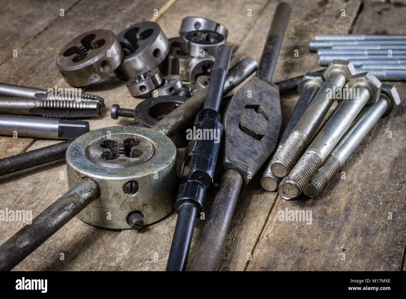 Metalwork tools on the workshop table. Threading dies and taps in an ...