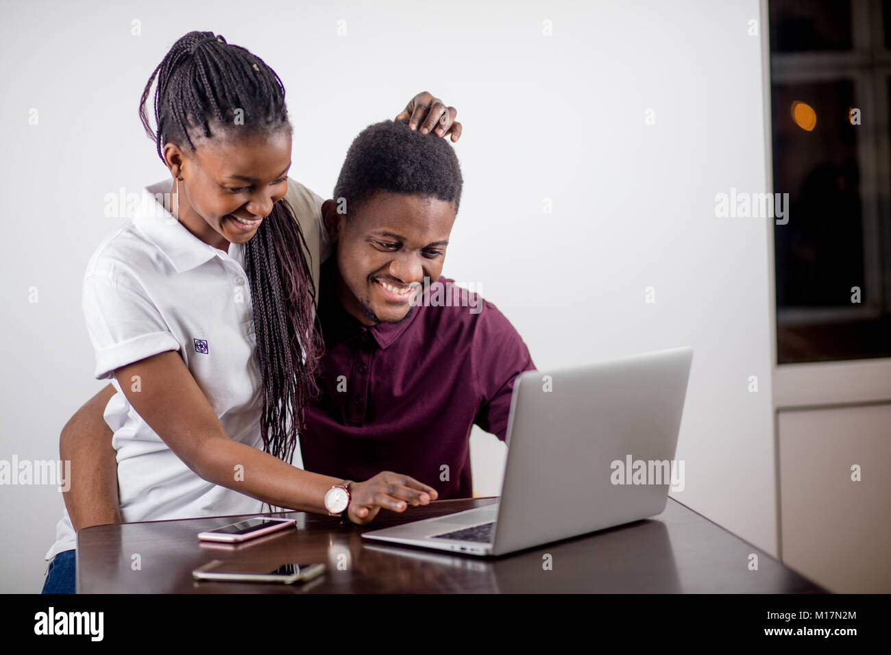 black girl sitting in front of laptop s looking on screen Stock Photo ...