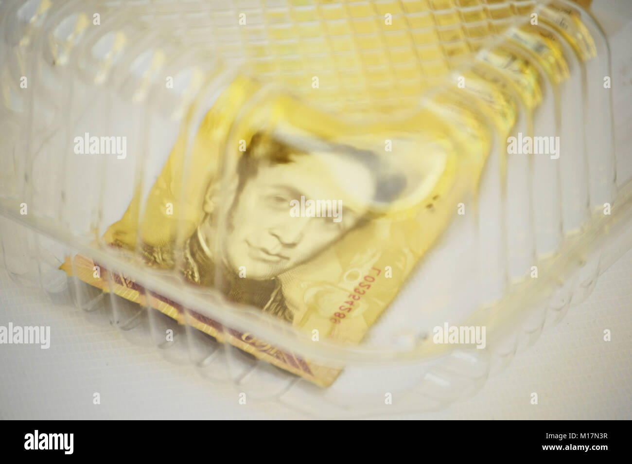 Bank notes inside plastic container. Cash crisis concept Stock Photo ...