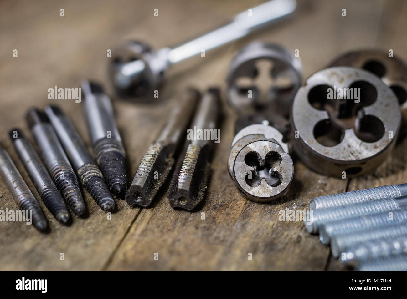 Metalwork tools on the workshop table. Threading dies and taps in an ...