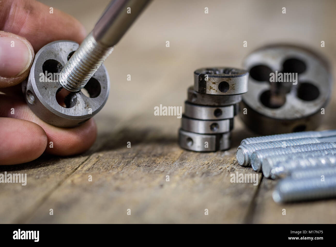 Metalwork tools on the workshop table. Threading dies and taps in an ...