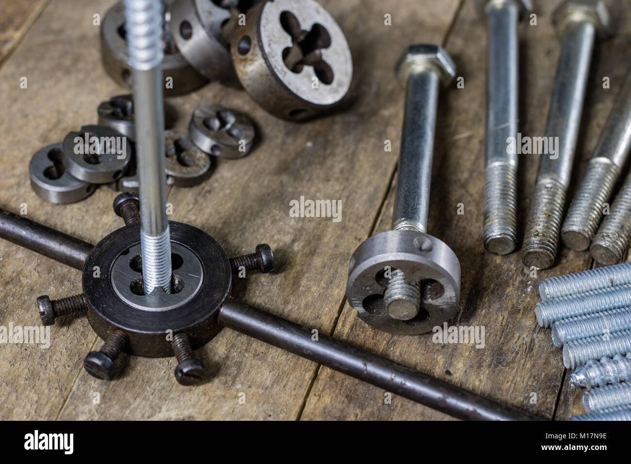 Metalwork tools on the workshop table. Threading dies and taps in an ...