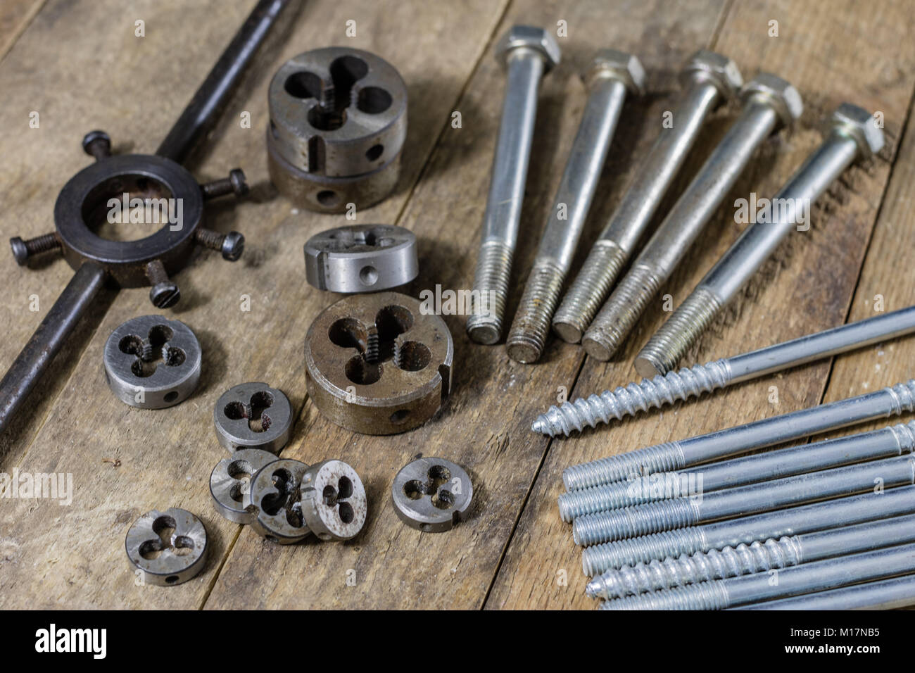 Metalwork tools on the workshop table. Threading dies and taps in an ...
