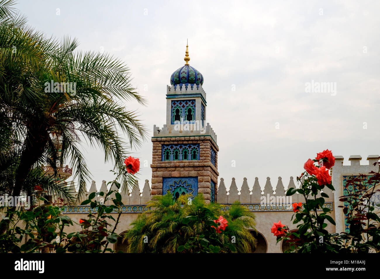 Blue Islamic Prayer Tower with Arabic windows. Palm trees and red roses ...