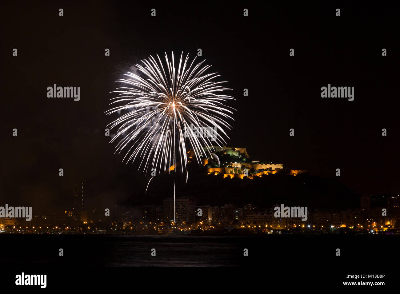 Fireworks at San Juan de Alicante with Santa Barbara castle in the ...