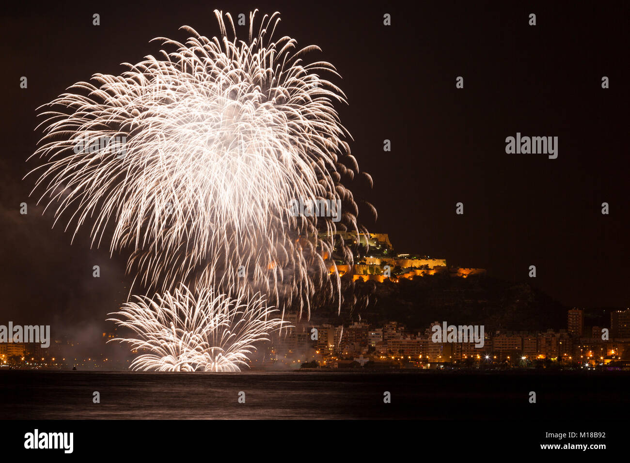 Fireworks at San Juan de Alicante with Santa Barbara castle in the ...