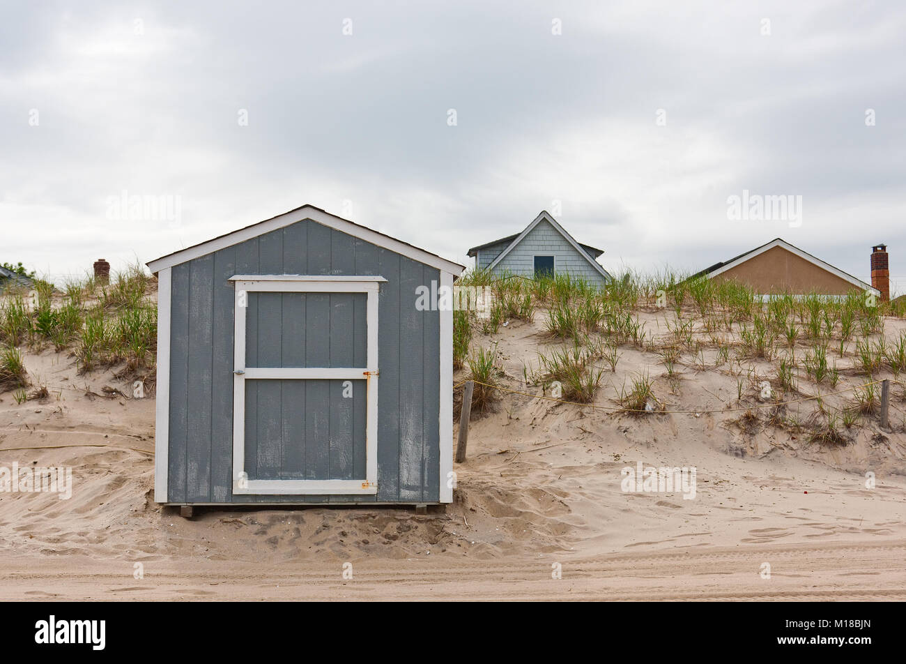 A storage shed in front of dunes on a beach at the New Jersey Shore ...