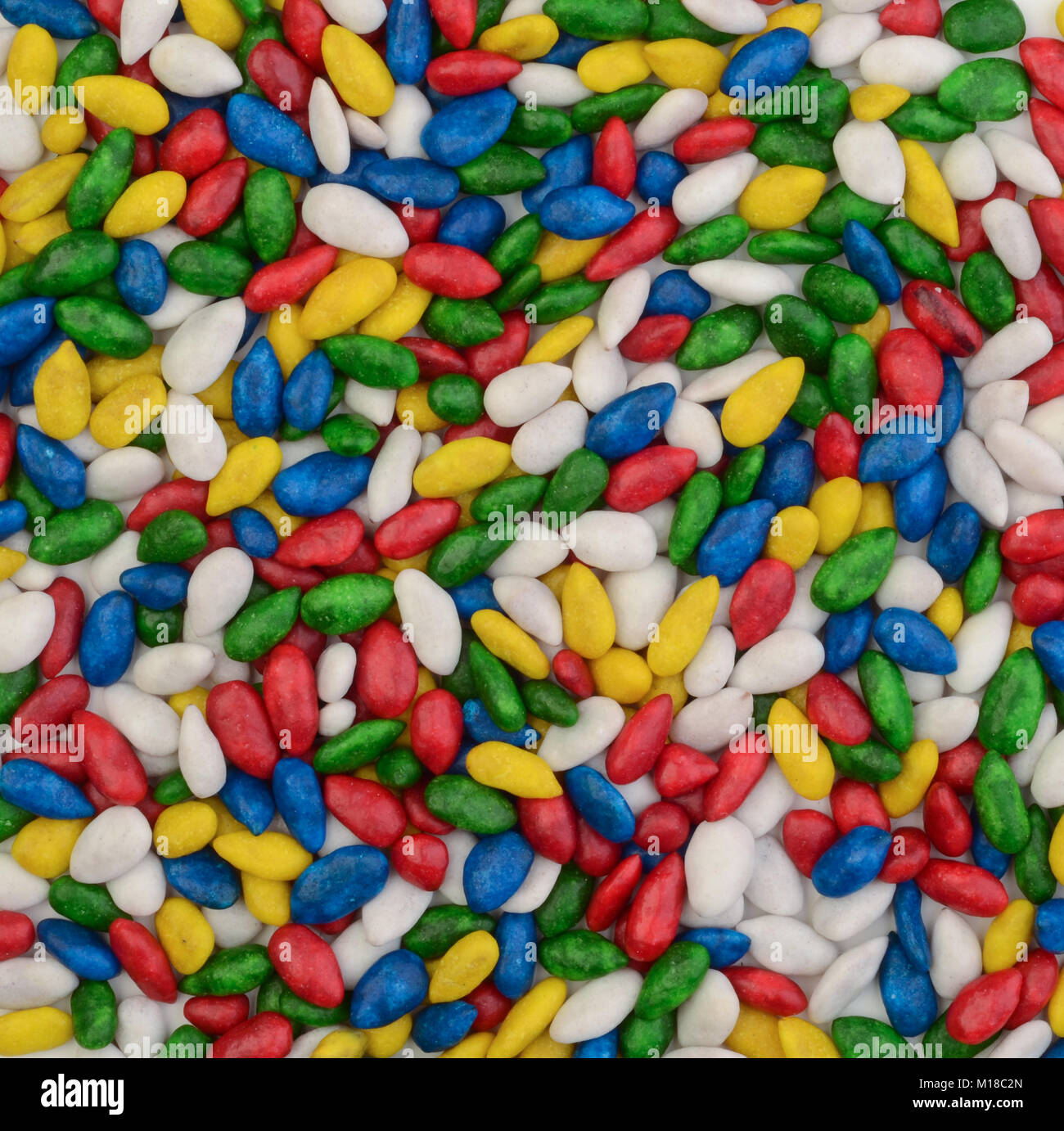 Multicolored sunflower seeds as background Stock Photo - Alamy