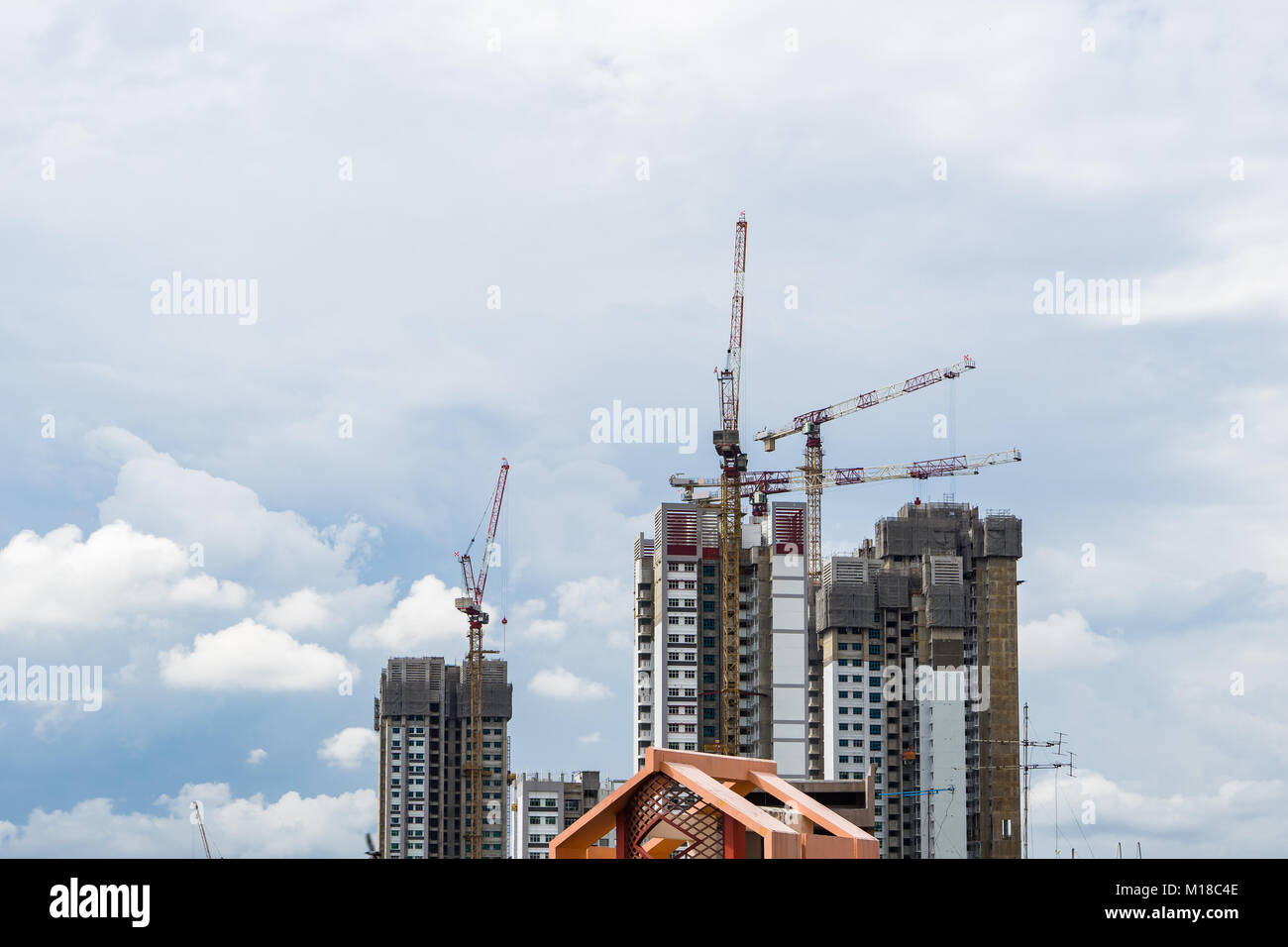 High rise tower crane and new unfinished residential townhouse under ...