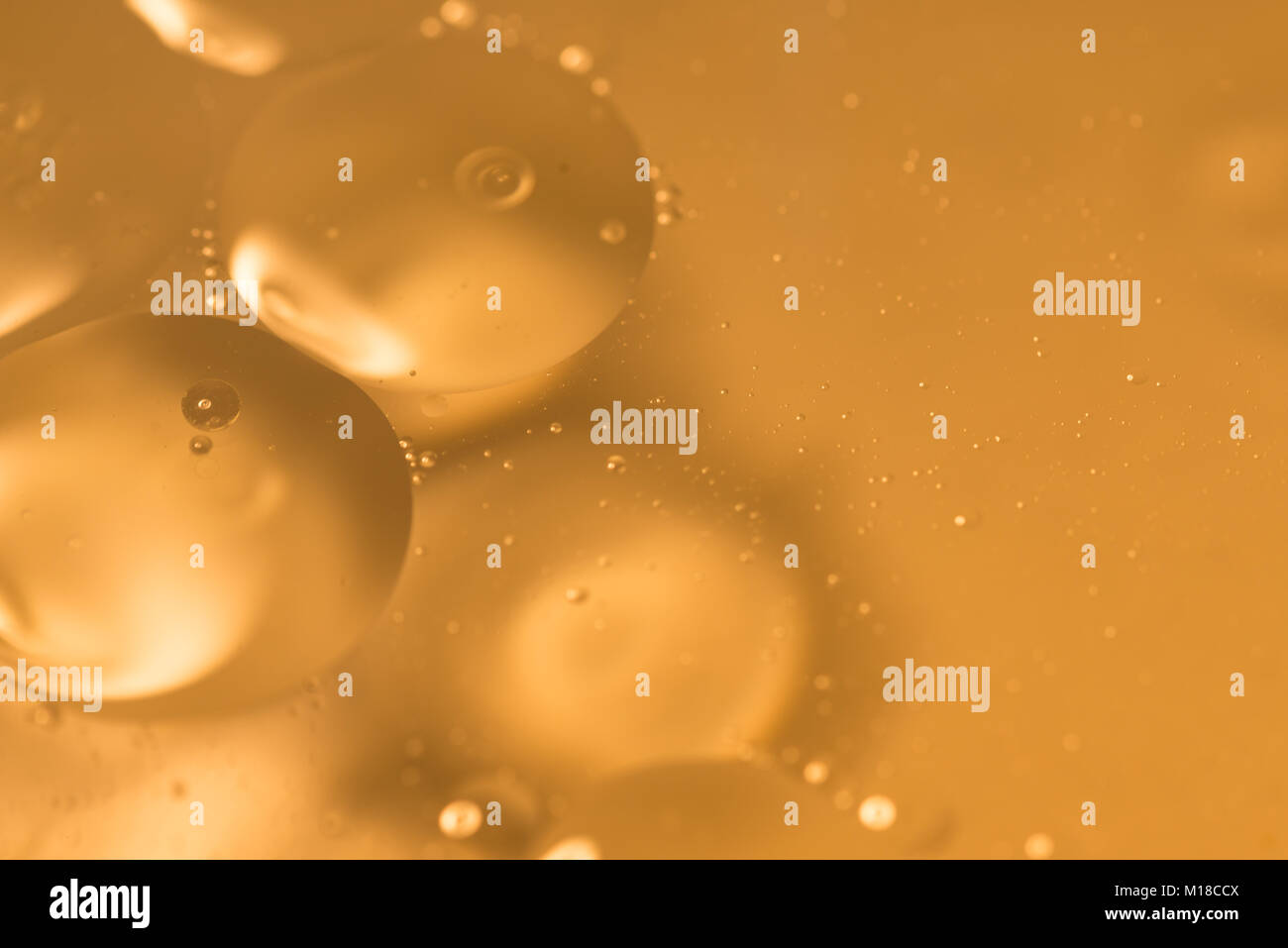 Golden oil and water macro background image Stock Photo - Alamy