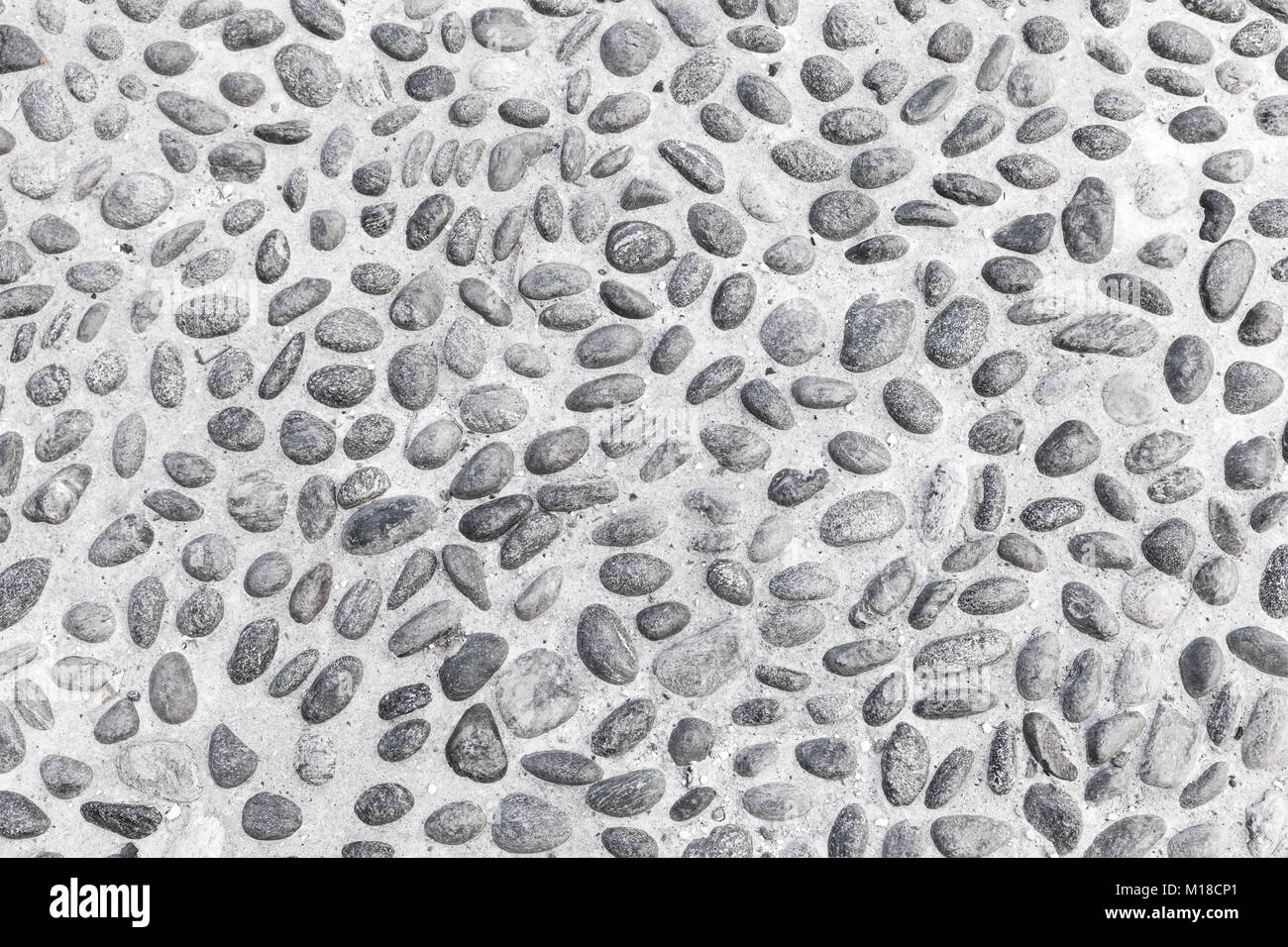 Small round stones in concrete floor, walking lane pavement background ...