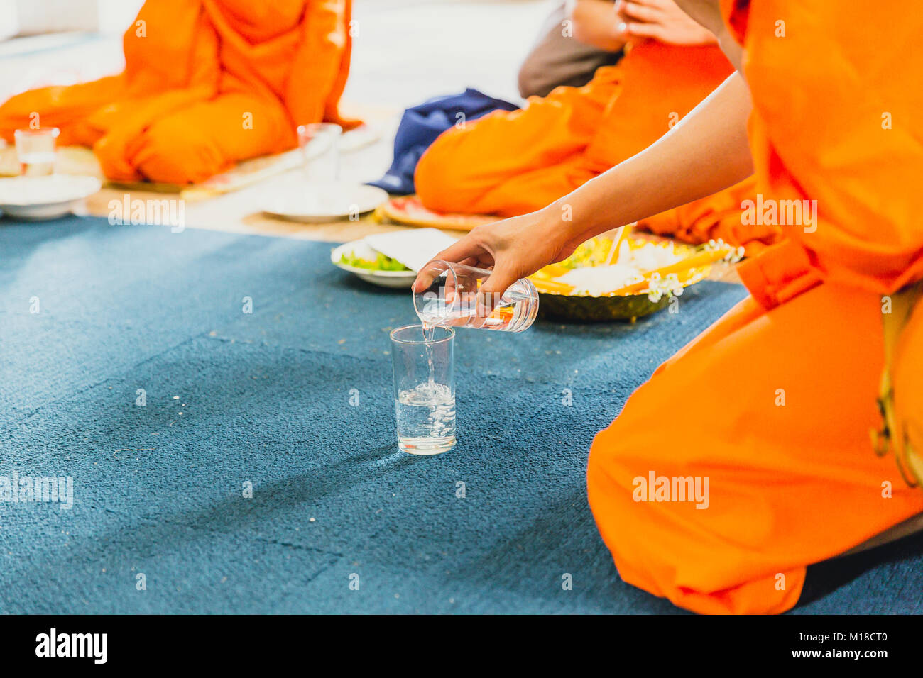 Thai monk pray and pouring water buddhist ritual in temple after ...