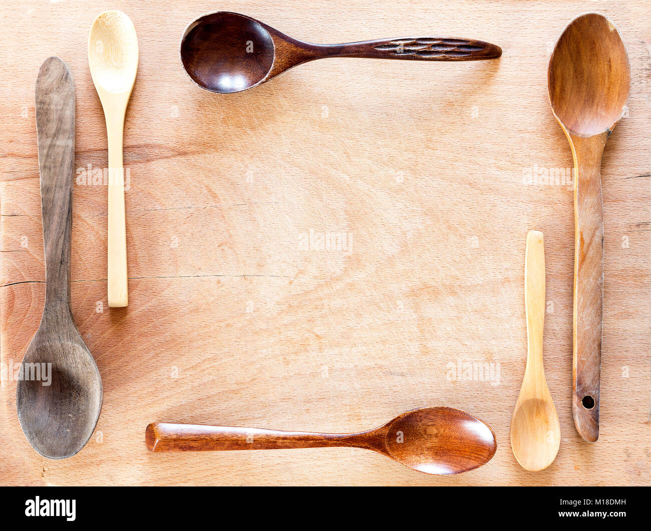 Wooden kitchenware frame on a wooden background from above. Studio shot ...