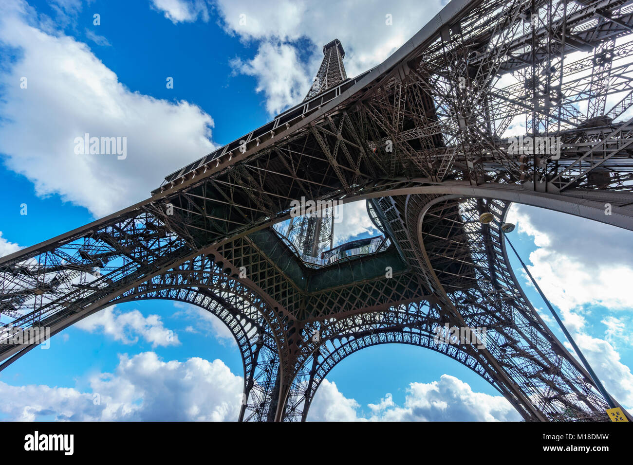 The Eiffel Tower bottom view of legs over blue sky Stock Photo - Alamy