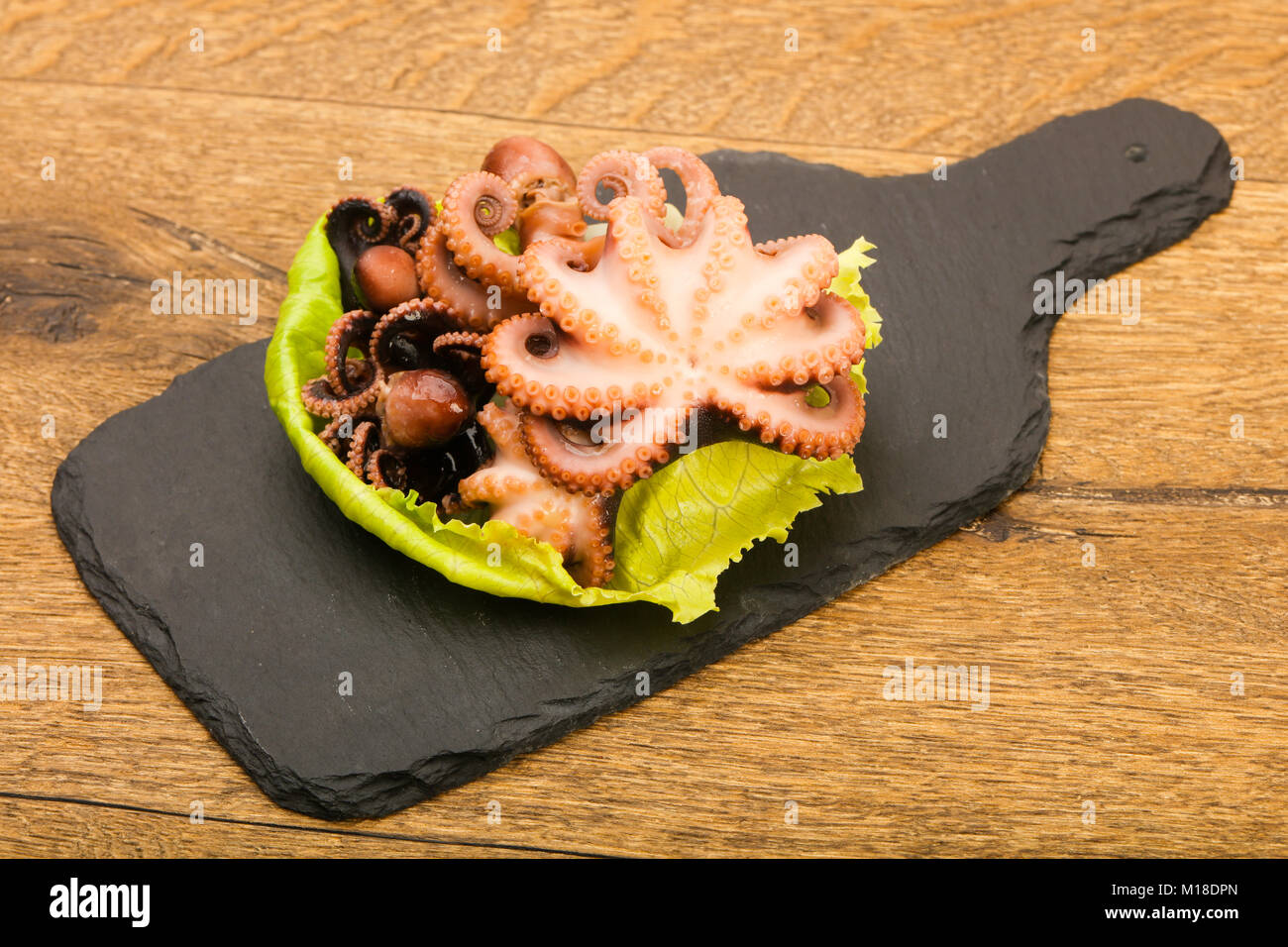 Boiled baby octopuses over salad leaves Stock Photo - Alamy