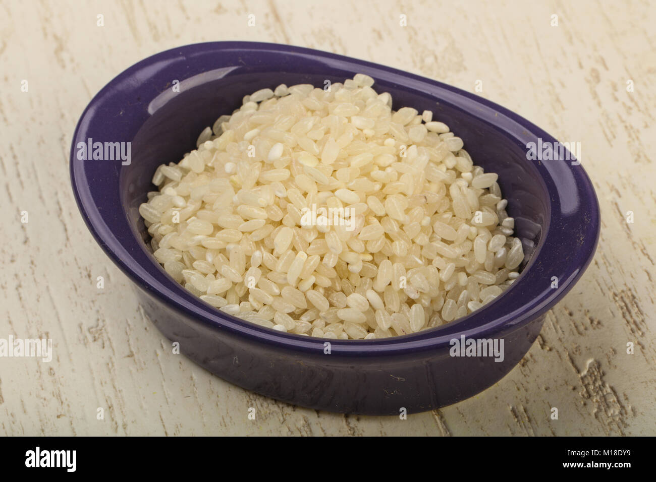 Raw rice heap in the bowl - ready for cooking Stock Photo - Alamy