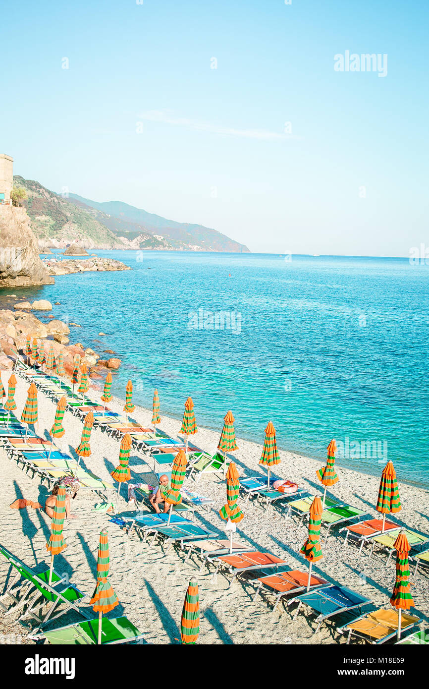 Sunbeds and umbrellas at beautiful european seashore in Monterosso in ...