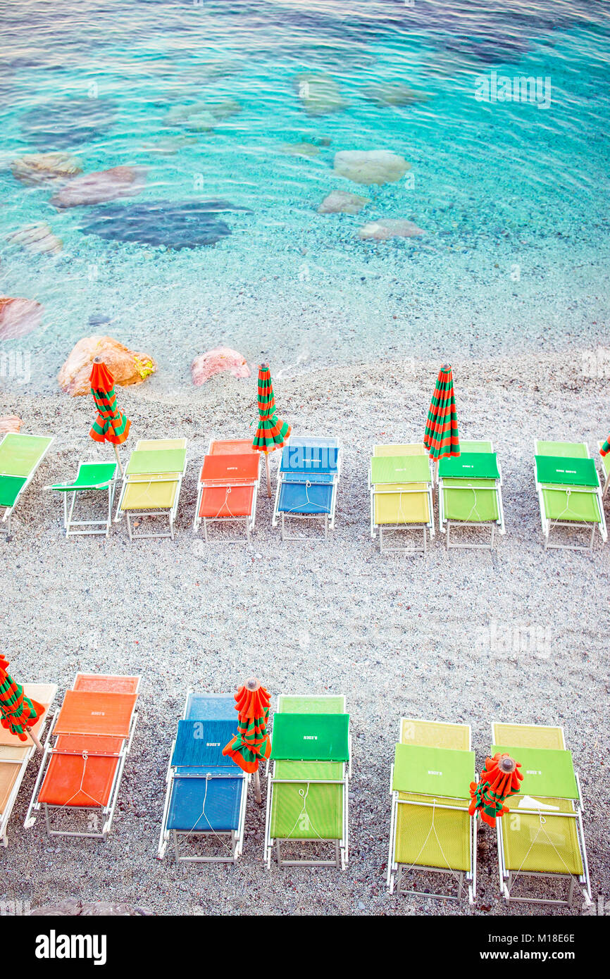 Sunbeds and umbrellas at beautiful european seashore in Monterosso in ...