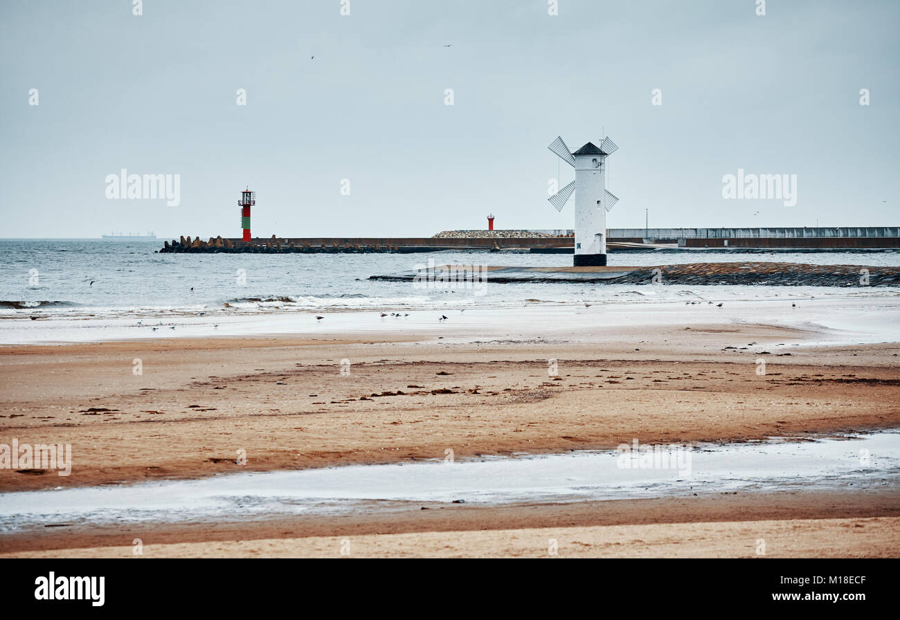 Windmill lighthouse in Swinoujscie on a cloudy day, color toned picture ...