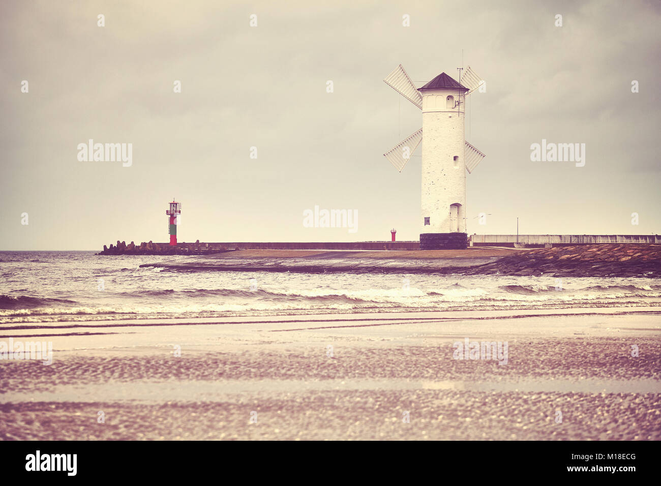 Windmill lighthouse in Swinoujscie on a cloudy day, color toned picture ...