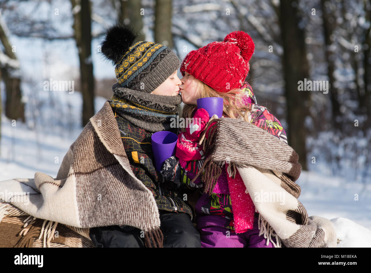 Romantic children valentines in winter forest. Kissing kids Stock Photo ...