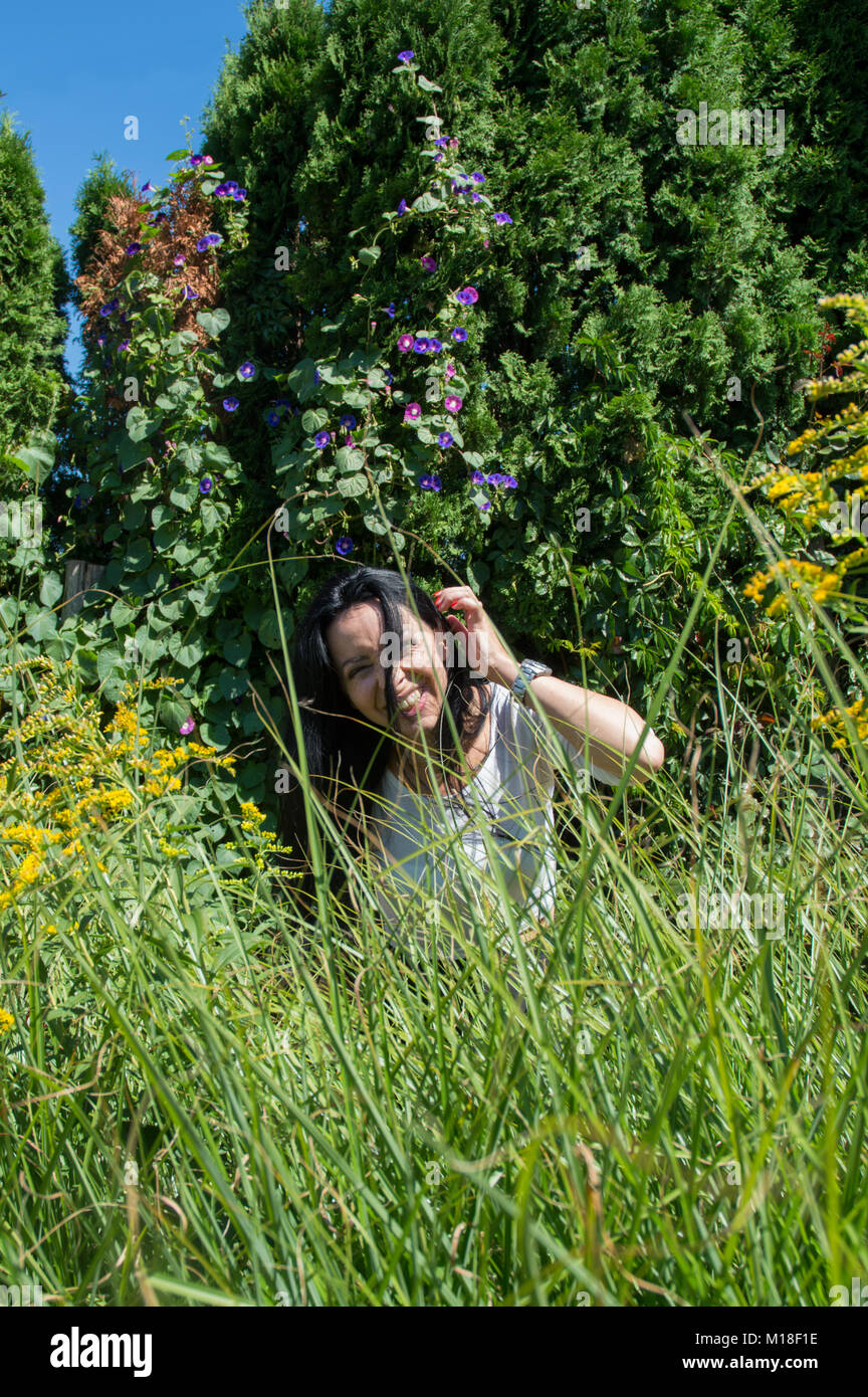 female laughing surrounded by greenery in nature Stock Photo - Alamy