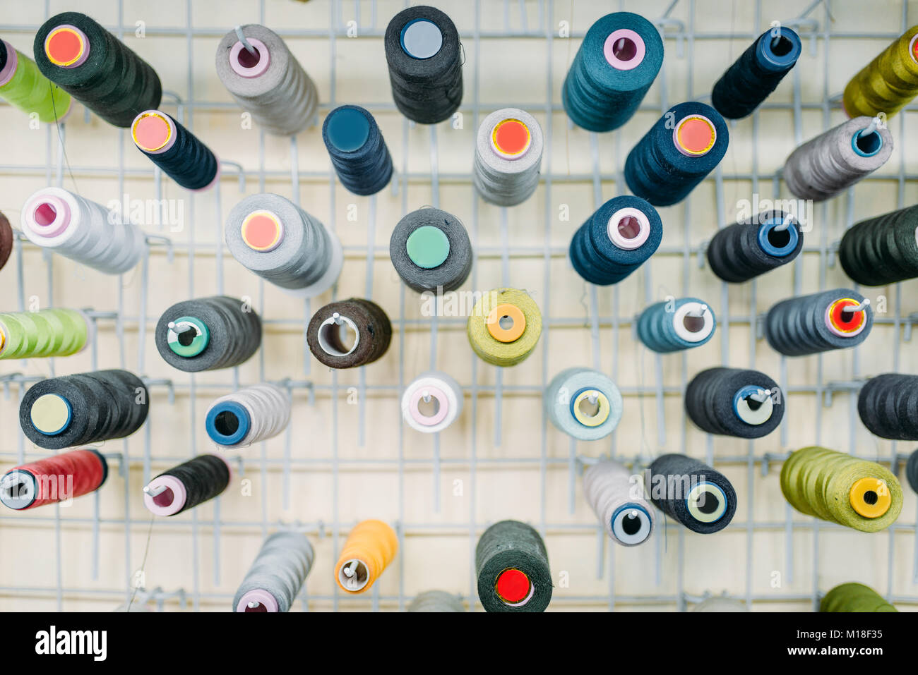 Colorful threads on spools closeup, side view, sewing material, yarn on ...