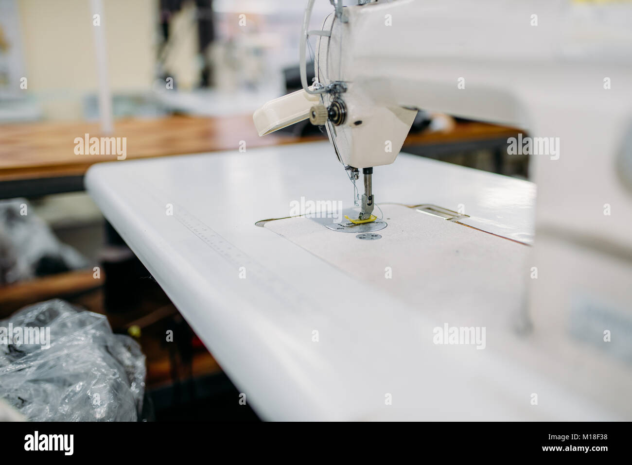 Sewing machine on clothing factory, nobody. Dressmaking industry ...