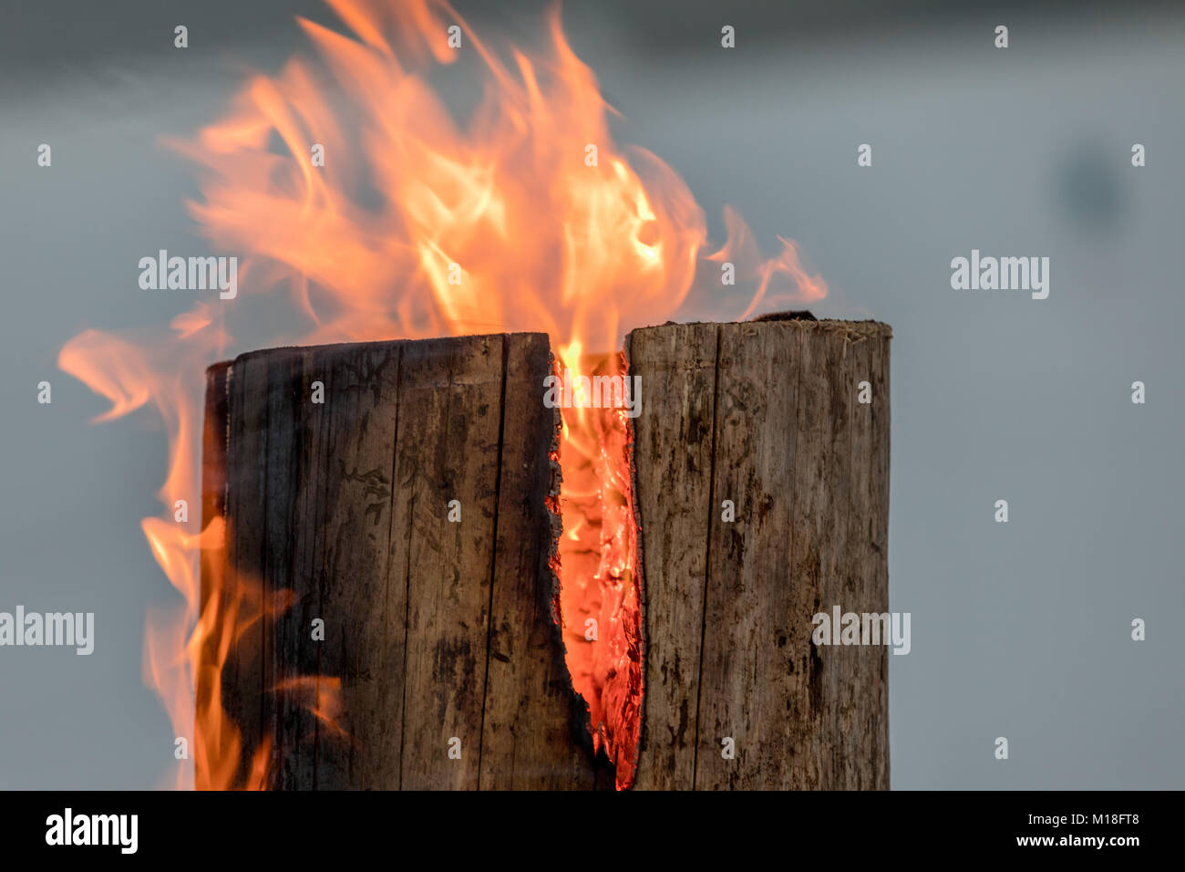 Swedish torch fire burning stub on plate for rest and for warming in ...
