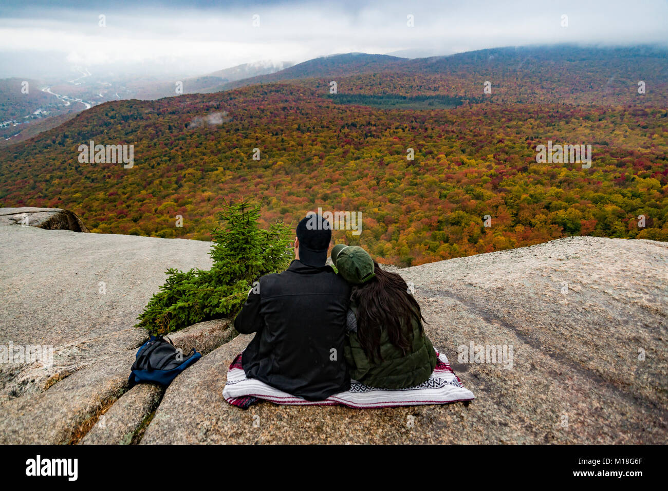 Two hikers watching fall foliage around Mount Washington in New ...