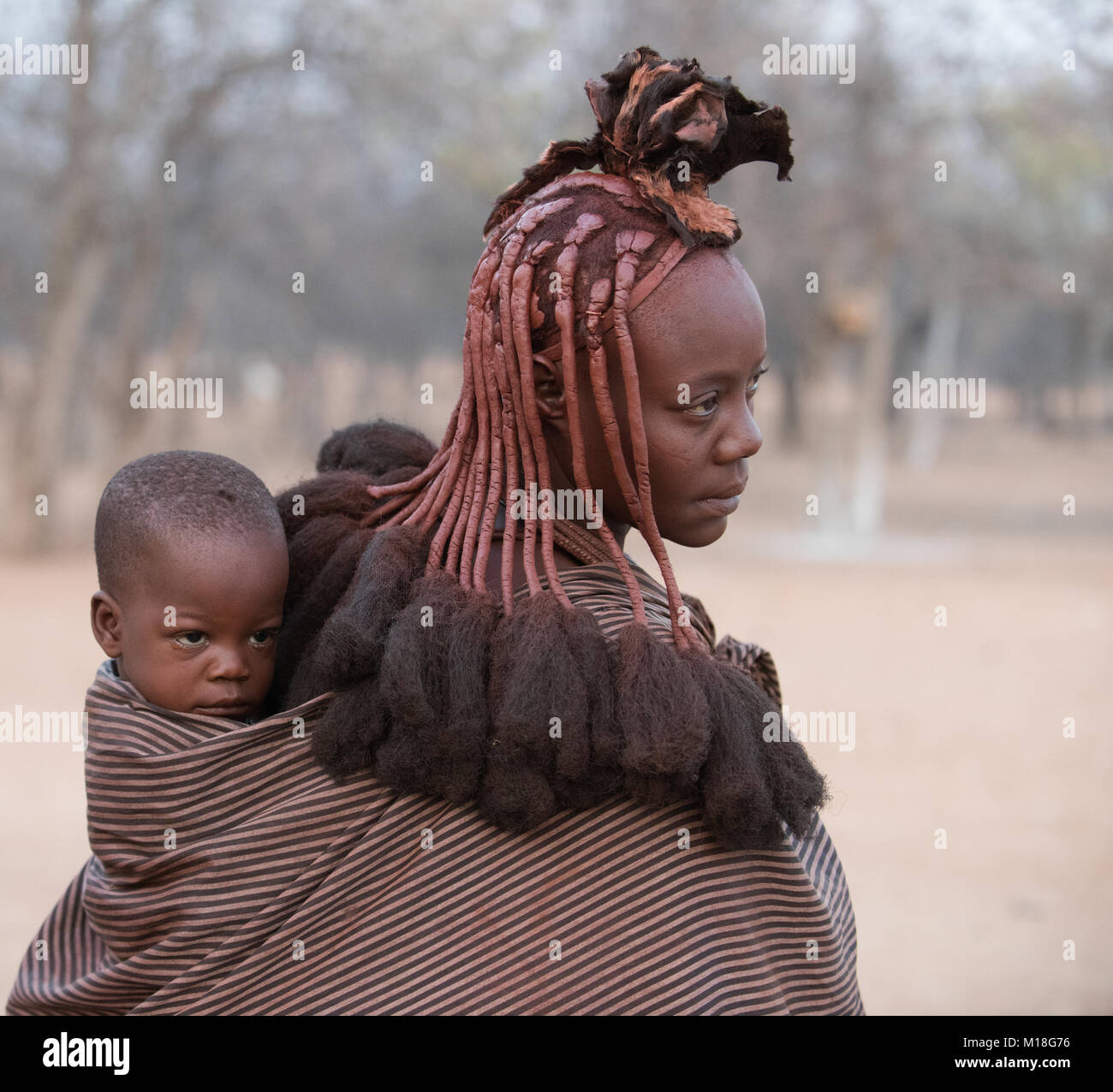 Young,married woman wearing a baby in a cloth,portrait,Kaokoveld ...
